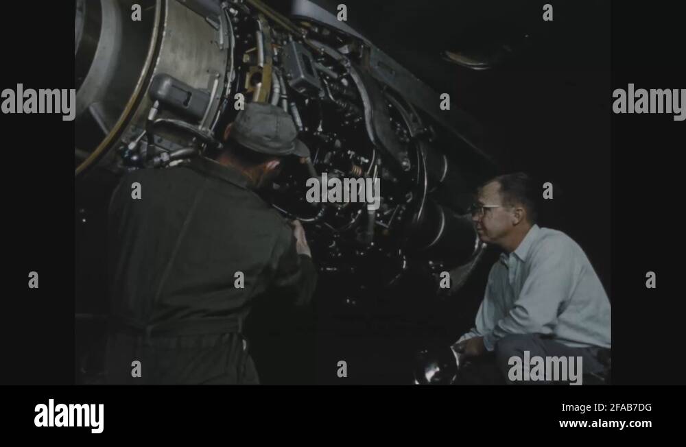 Engineer explains parts of B-47 engine and man photographs B-47 engine ...