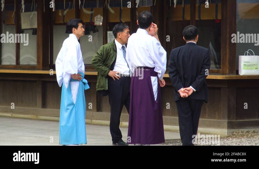 A group of japanese men wearing normal and traditional clothes in ...