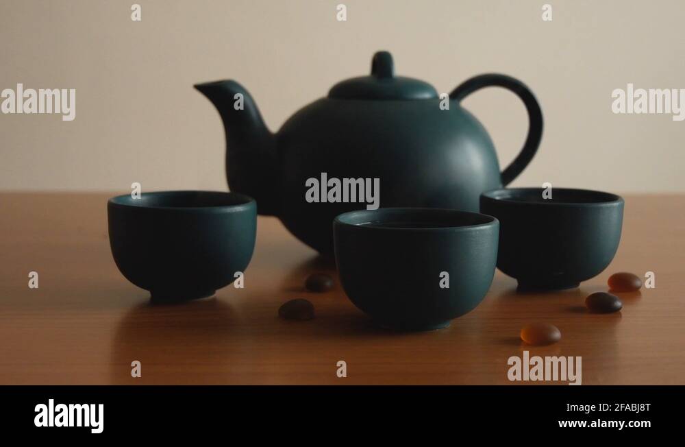 minimal background of a green japanese tea set with steam coming out of ...