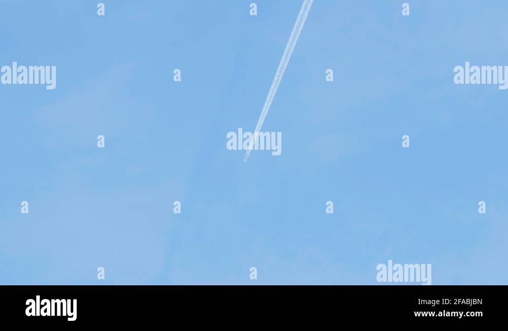 jet stream of airplane going in blue sky Stock Video Footage - Alamy