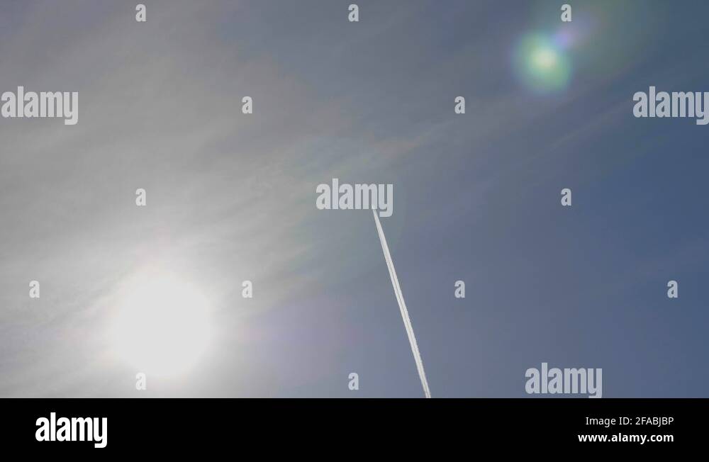 jet stream of airplane going in blue sky Stock Video Footage - Alamy