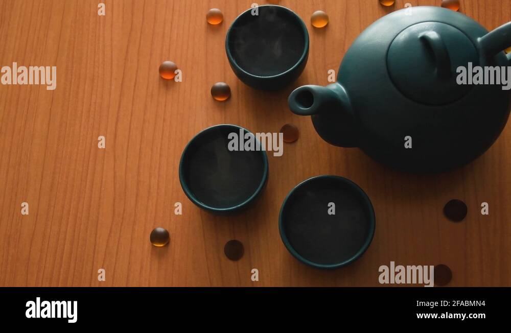 minimal background of a green japanese tea set with steam coming out of ...