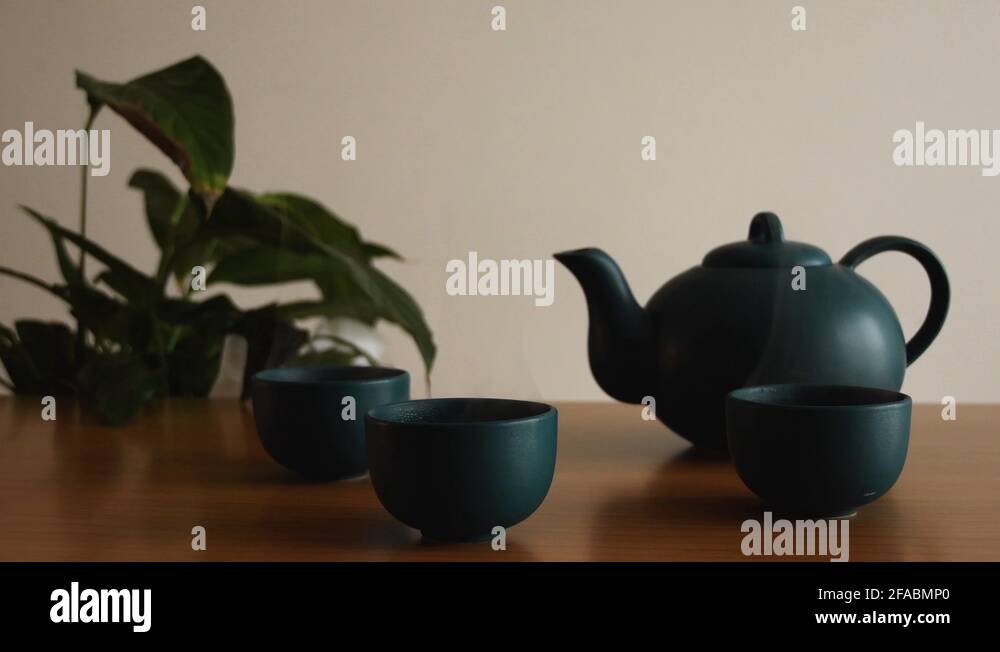 minimal background of a green japanese tea set with steam coming out of ...
