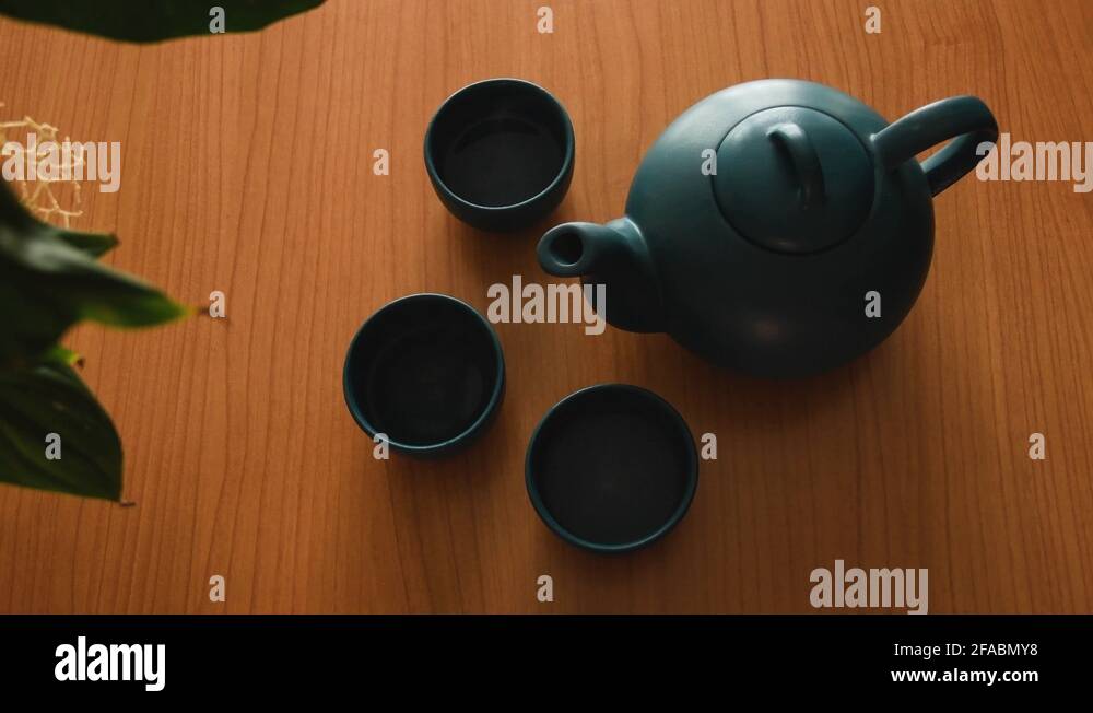 minimal background of a green japanese tea set with steam coming out of ...
