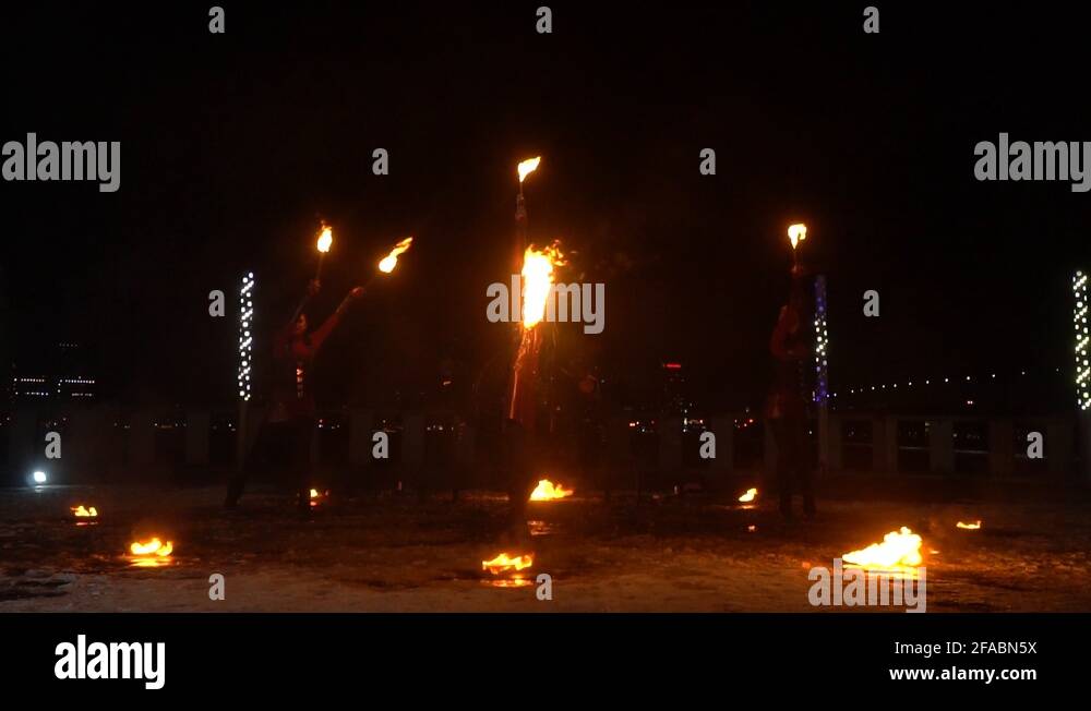 Bright and colorful fire performance on the street with amazing sparks ...