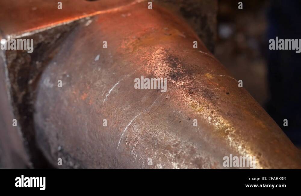 Close Up Detail Shot of Hot Metal Being Hammered to Create a Texture on ...