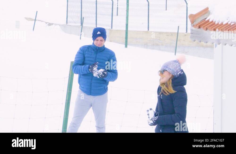 Two girls are throwing snowball to two guys and fail Stock Video ...