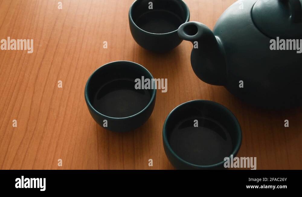 minimal background of a green japanese tea set with steam coming out of ...
