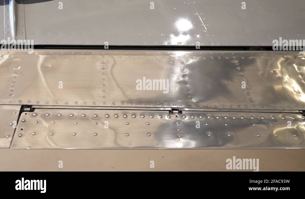 Detail of metal rivetted control surfaces of WWII P-51 Mustang plane ...