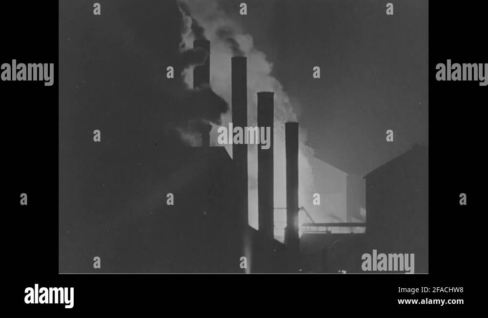 Smokestack emit smoke and fire flames rise in the factory - 1930 Stock ...
