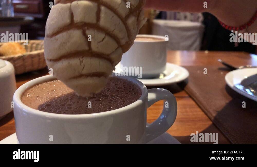 Mexican concha bread into a hot cup of chocolate Stock Video Footage ...