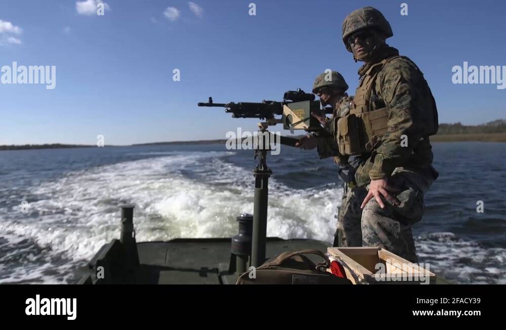 Crewman aiming M240 machine gun from bridge erection boat Stock Video ...