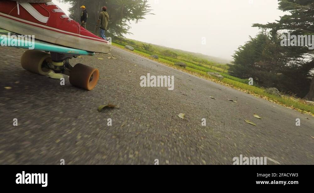 Skateboarding around a fun curve with a group of friends Stock Video ...