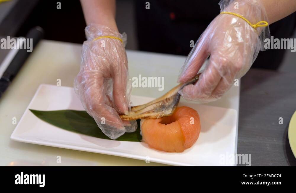 Close scene of working process. Chef is making a presentation of dish ...