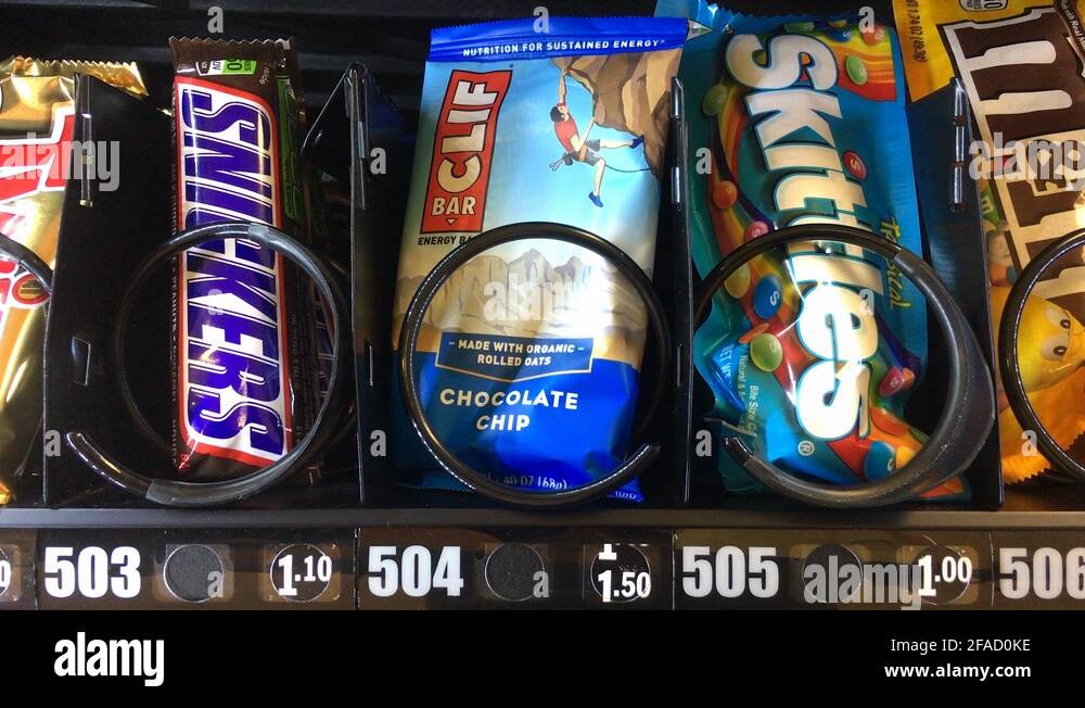 Snickers chocolate candy bar falling from vending machine Stock Video ...