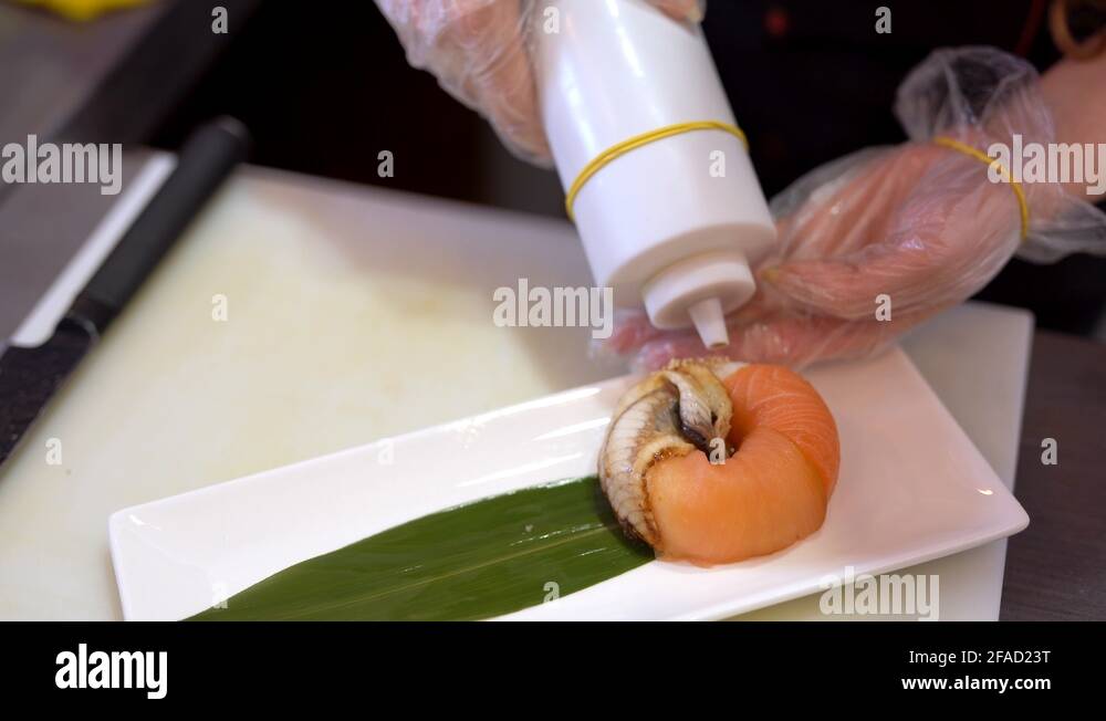 Close scene of working process. Chef is making a presentation of dish ...