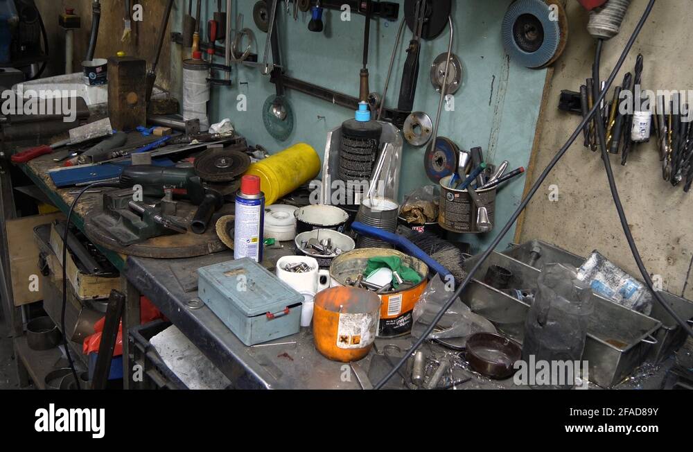 Footage of messy desk at workshop metal place. Metallic tools and ...