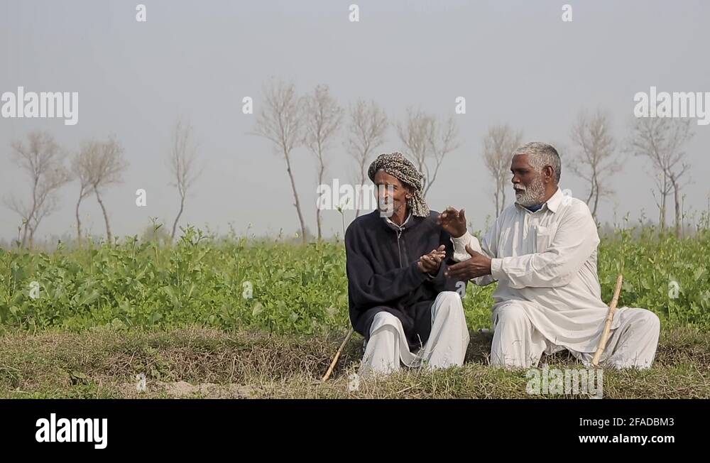 Two old men have fun & show friendship in a farming village in Pakistan ...