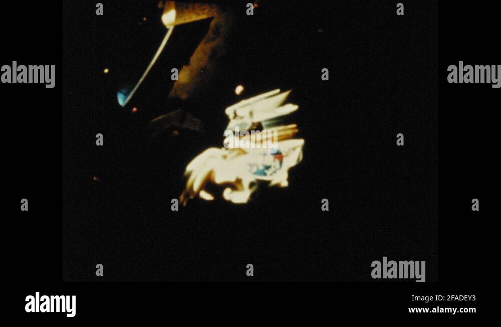 1960s: Astronaut adjusts camera in cockpit of command module. Gemini ...