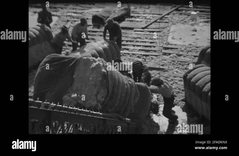 Cotton bales moved on conveyor belt and load into ship - 1930 Stock ...