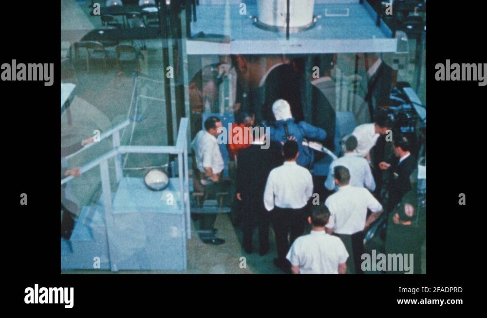 1960s: UNITED STATES: astronauts inspect transfer tunnel. Scientist ...