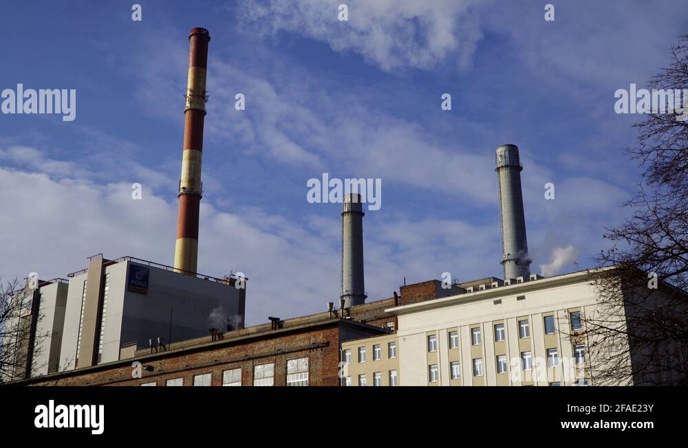 Steam emissions are released into the environment from a Industrial ...