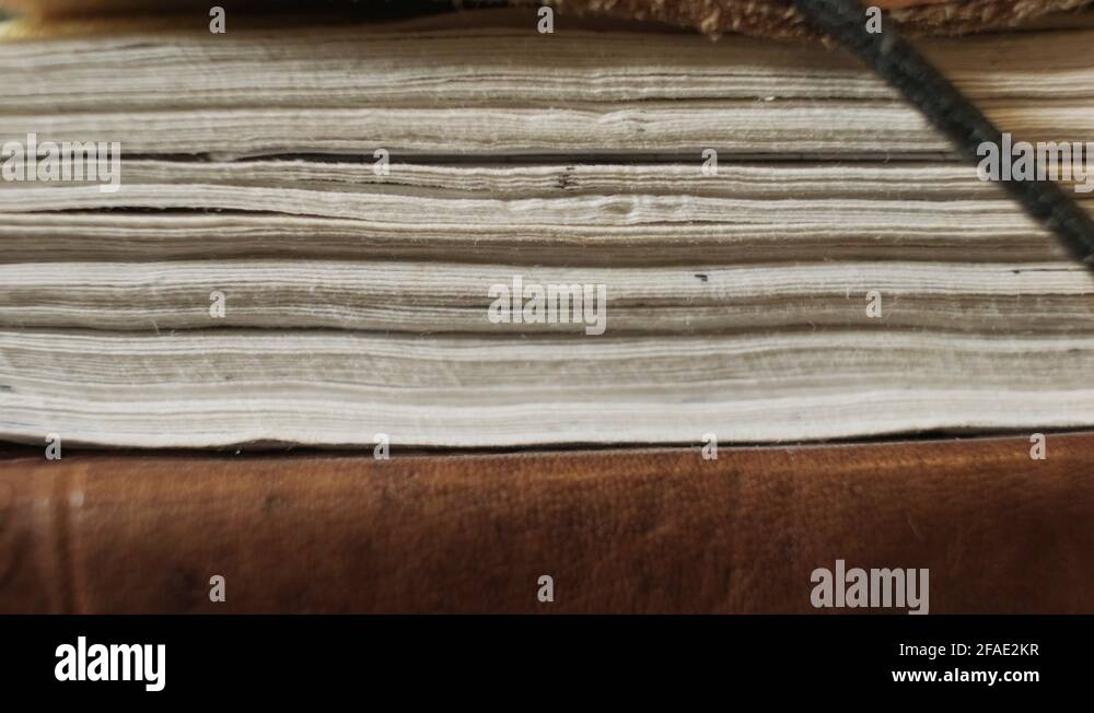 Old isolated mysterious pages in a magical leather book horizontal pan ...