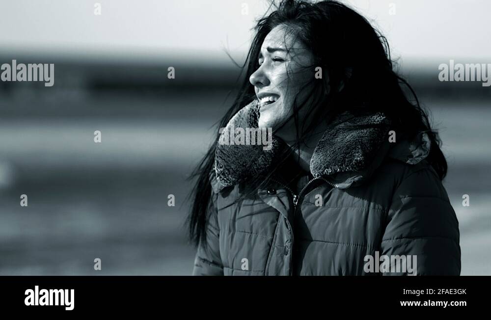 Woman feeling pain and grief crying in front of the ocean Stock Video ...