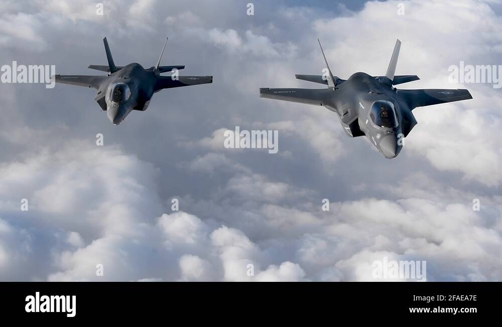 Boeing KC-135 Stratotanker and Martin F-35 Lightning II fly over cloud ...