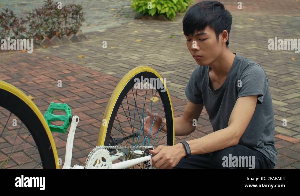 Man fixing bike Stock Videos & Footage - HD and 4K Video Clips - Alamy