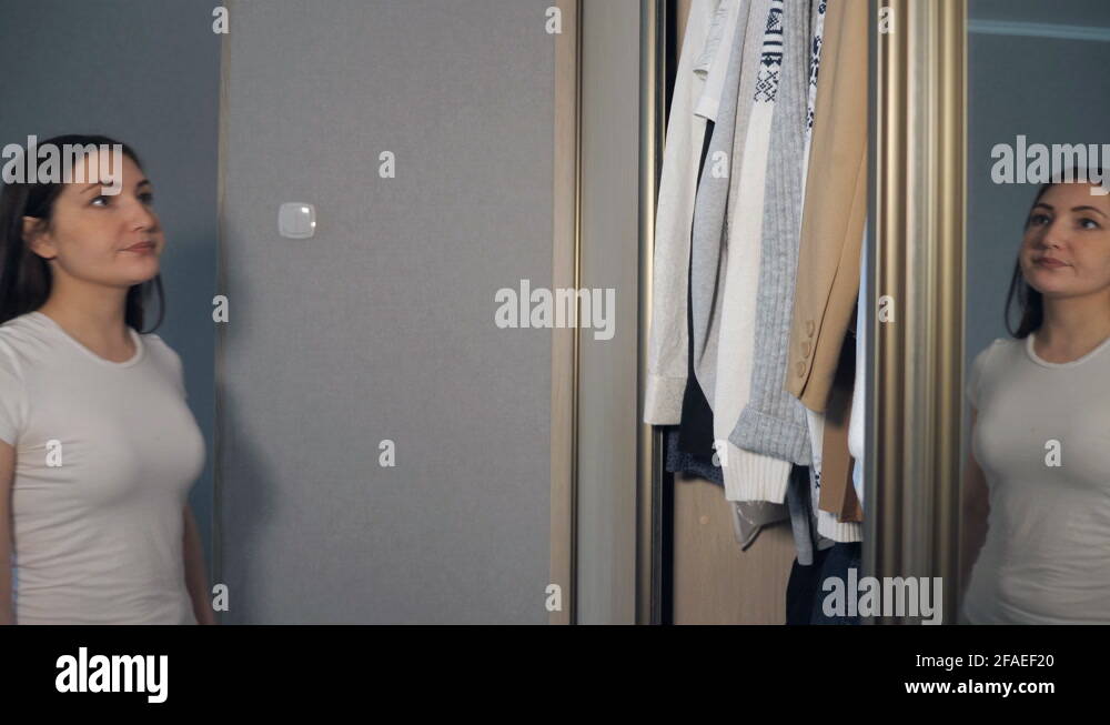 Smiling girl choosing clothes in wardrobe at home Stock Video Footage ...