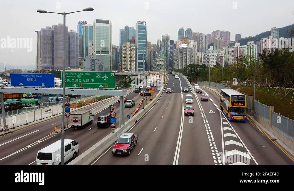 Traffic in Hong Kong on the expressway with the skyline in the ...