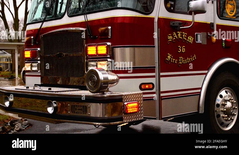 In focus pan and zoom footage of the front end and side of a fire truck ...