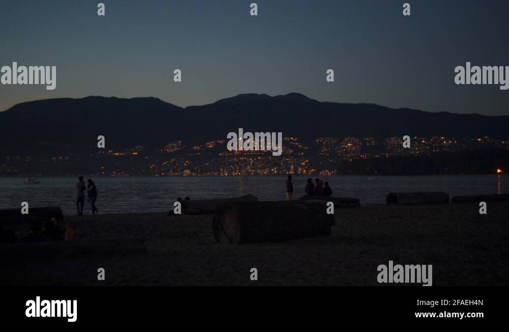 People Congregating on Kits Beach During Dusk the West Vancouver Lights ...