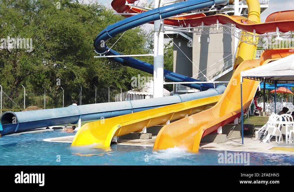 Slow motion footage of people playing in the water park. Kids splash ...