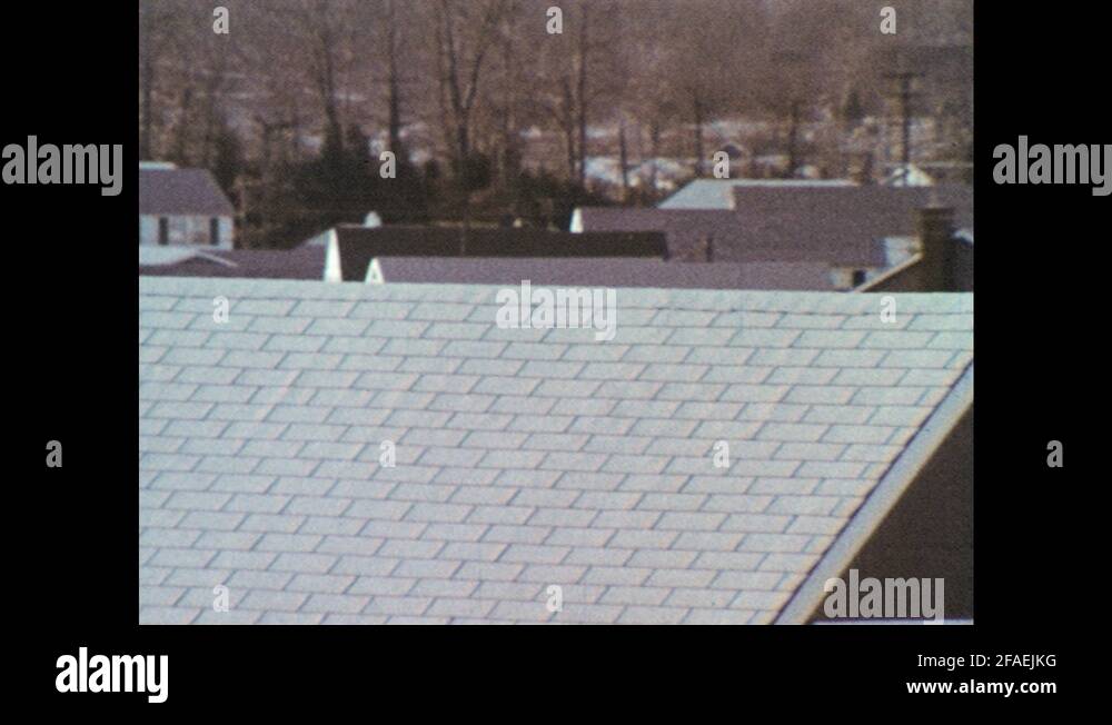 1970s: Rooftops of houses in dense suburban neighborhood. Aerials and ...