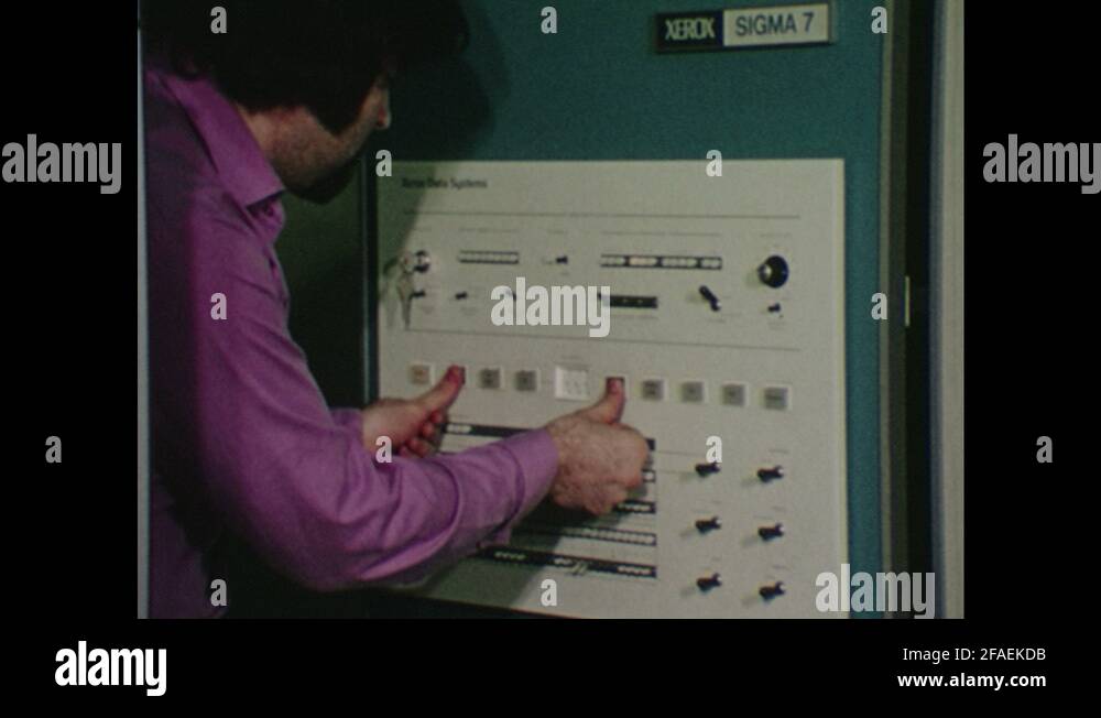 1970s: Man presses button on computer. People typing on keyboards ...