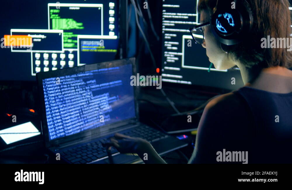 Girl types on a laptop, hacking system. Cyber crime and hacking concept ...