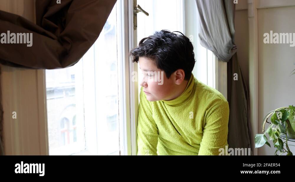 Sad boy watching out a window 3 Stock Video Footage - Alamy