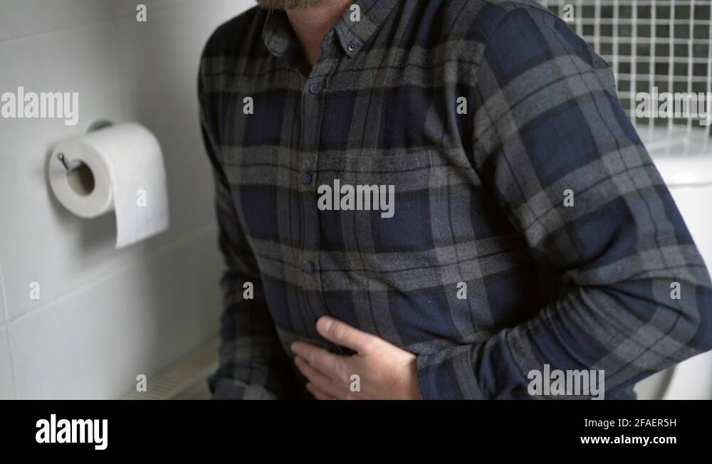 Constipated man in restroom rubbing painful stomach Stock Video Footage ...