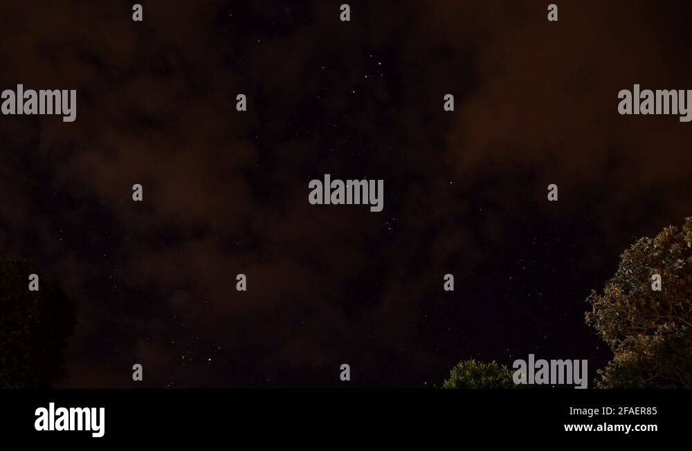 Fasting clouds travelling across night sky to reveal stars behind ...