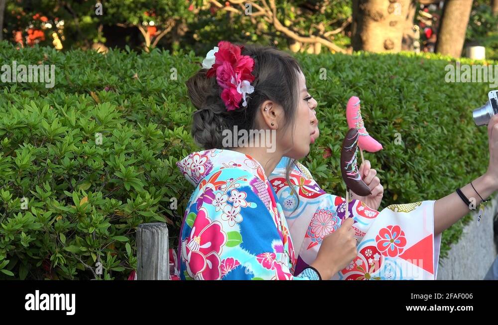 Two Japanese girls in traditional kimono is making selfie.Tokyo, Japan ...