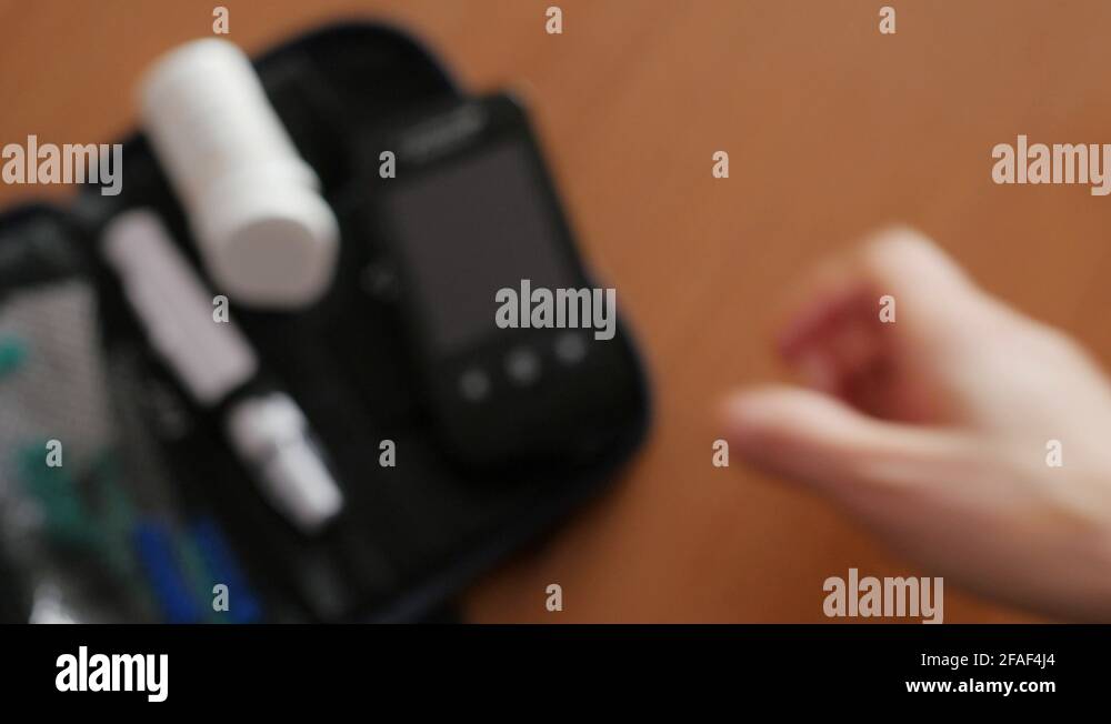 inserting strip measuring level of glucose blood in glucometer, glucose ...