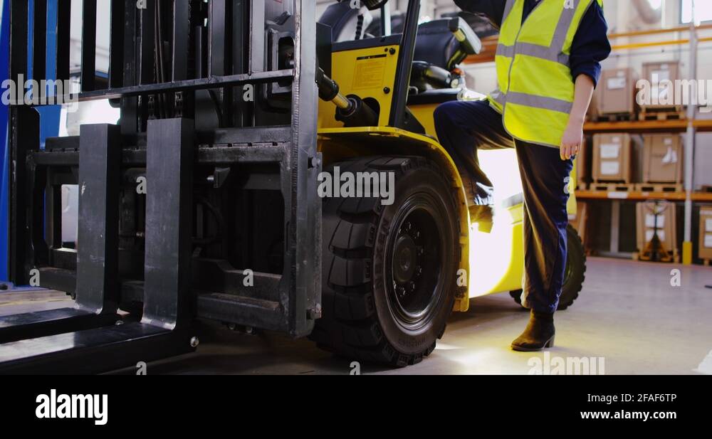 4K Portrait of beautiful smiling forklift operator in distribution ...