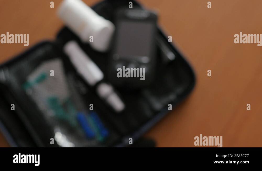 inserting strip measuring level of glucose blood in glucometer, glucose ...