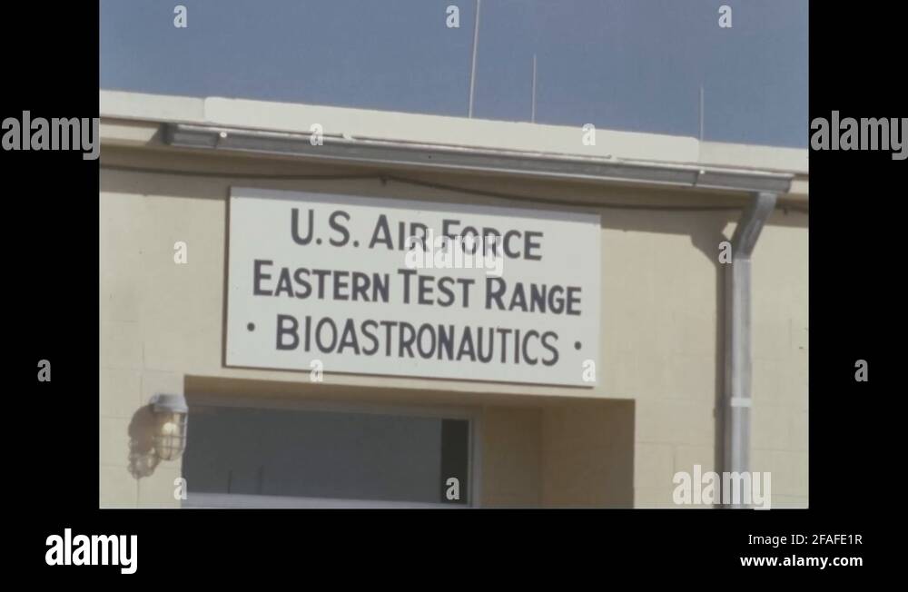 Eastern Test Range building, red cross truck and men around building ...