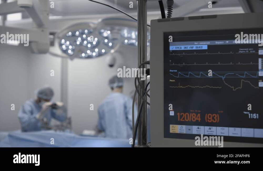 Modern surgery room with surgeons and Display of vital signs and ...
