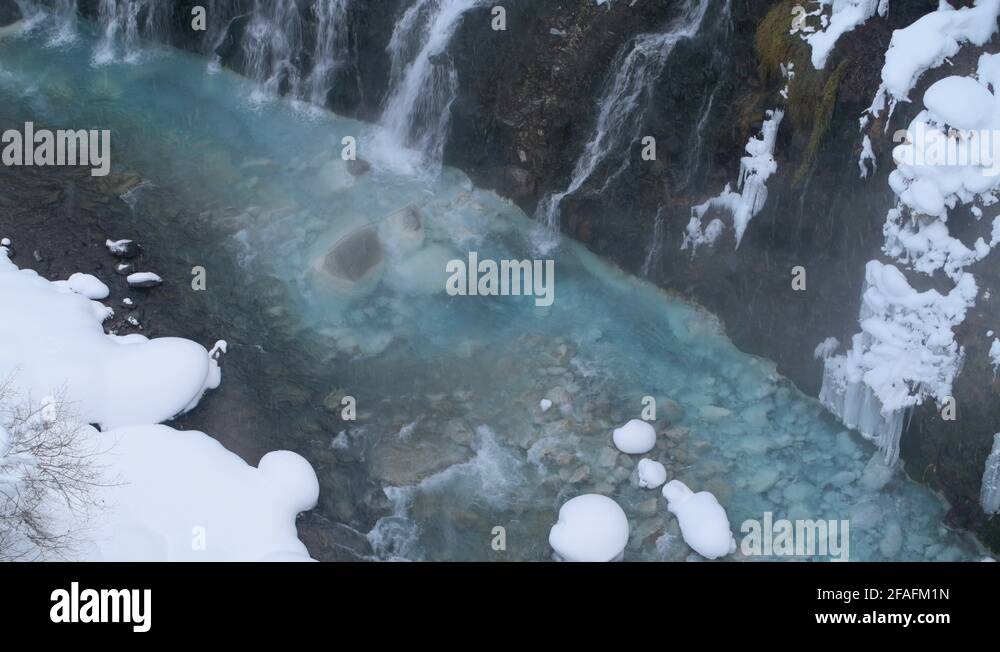 Partially frozen Shirahige waterfall under snowfall, Hokkaido, Japan ...