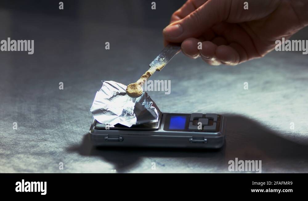 Drug dealer weighing a drug on a digital scale Stock Video Footage - Alamy