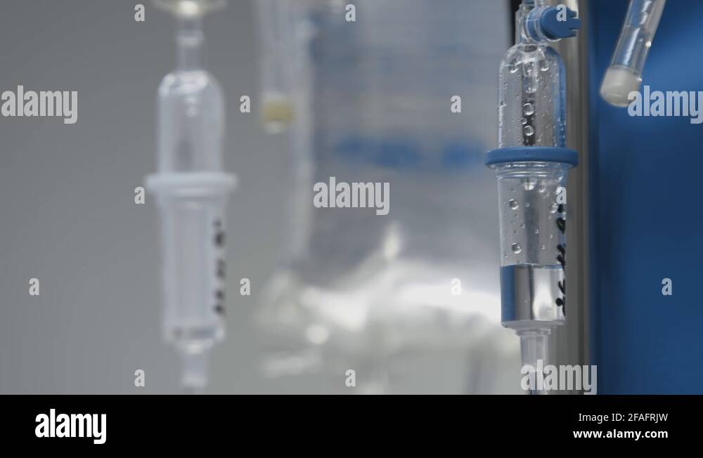 Dropper close-up with dripping medicine in operating room of modern ...